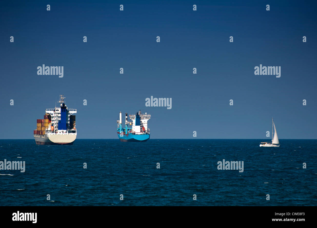 Commercial container ships on blue sky Stock Photo - Alamy