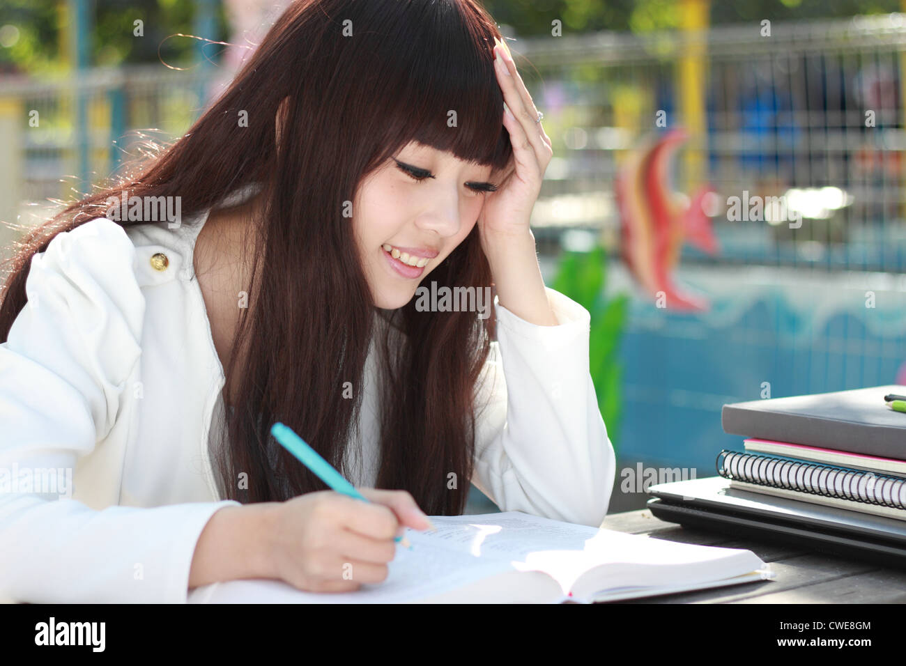 A smiling Asian student is studying Stock Photo - Alamy