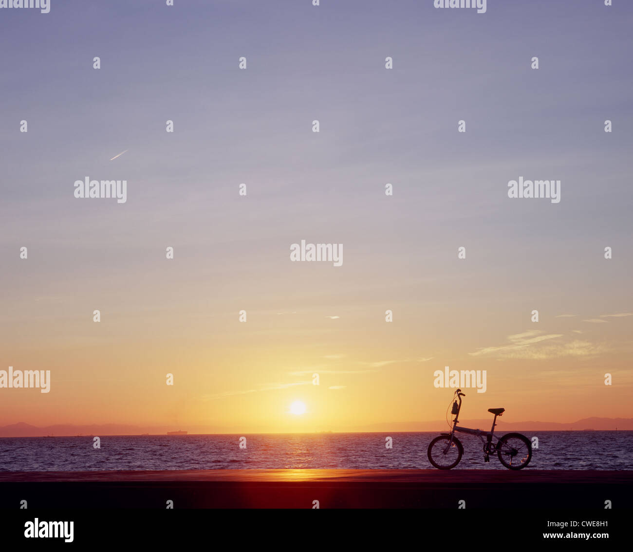 Bicycle beach sunset hi-res stock photography and images - Alamy