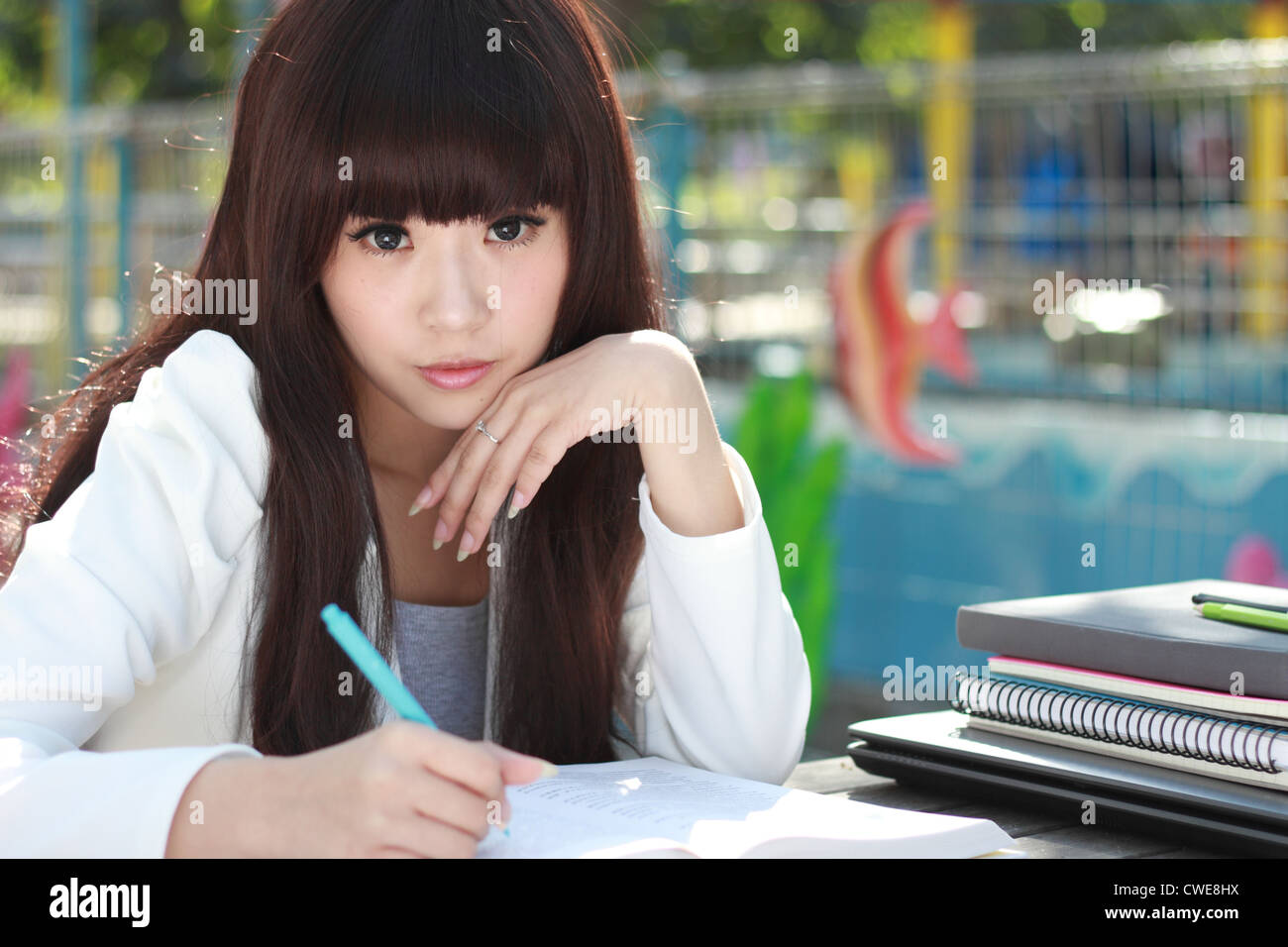 A smiling Asian student is studying Stock Photo - Alamy