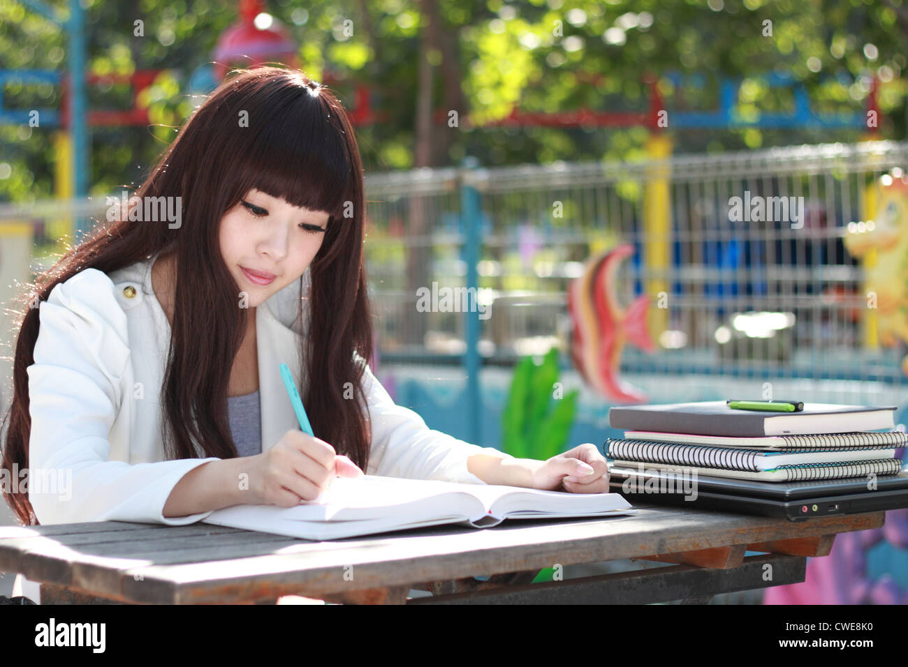 A smiling Asian student is studying Stock Photo - Alamy