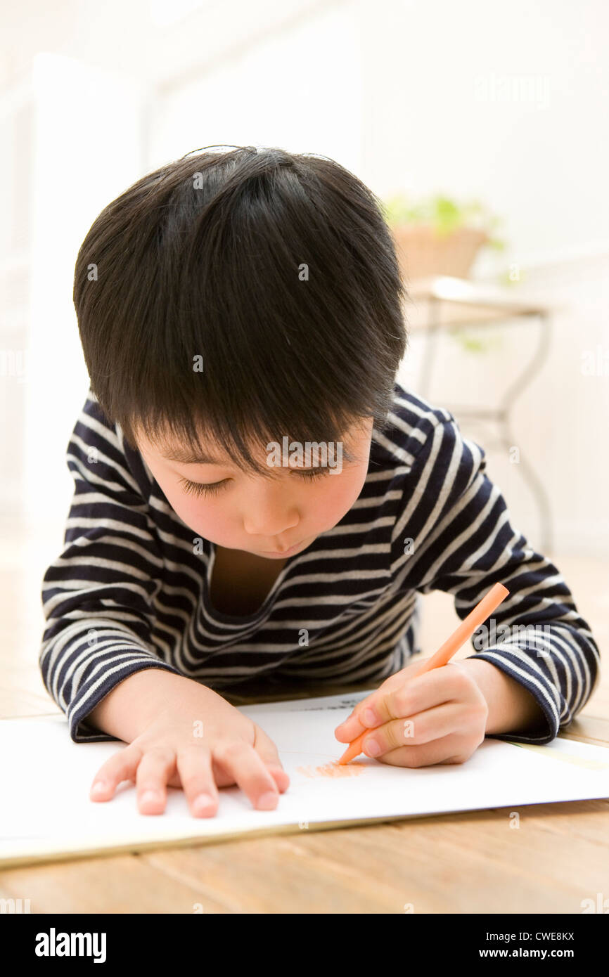 Boy lying on belly drawing hi-res stock photography and images - Alamy