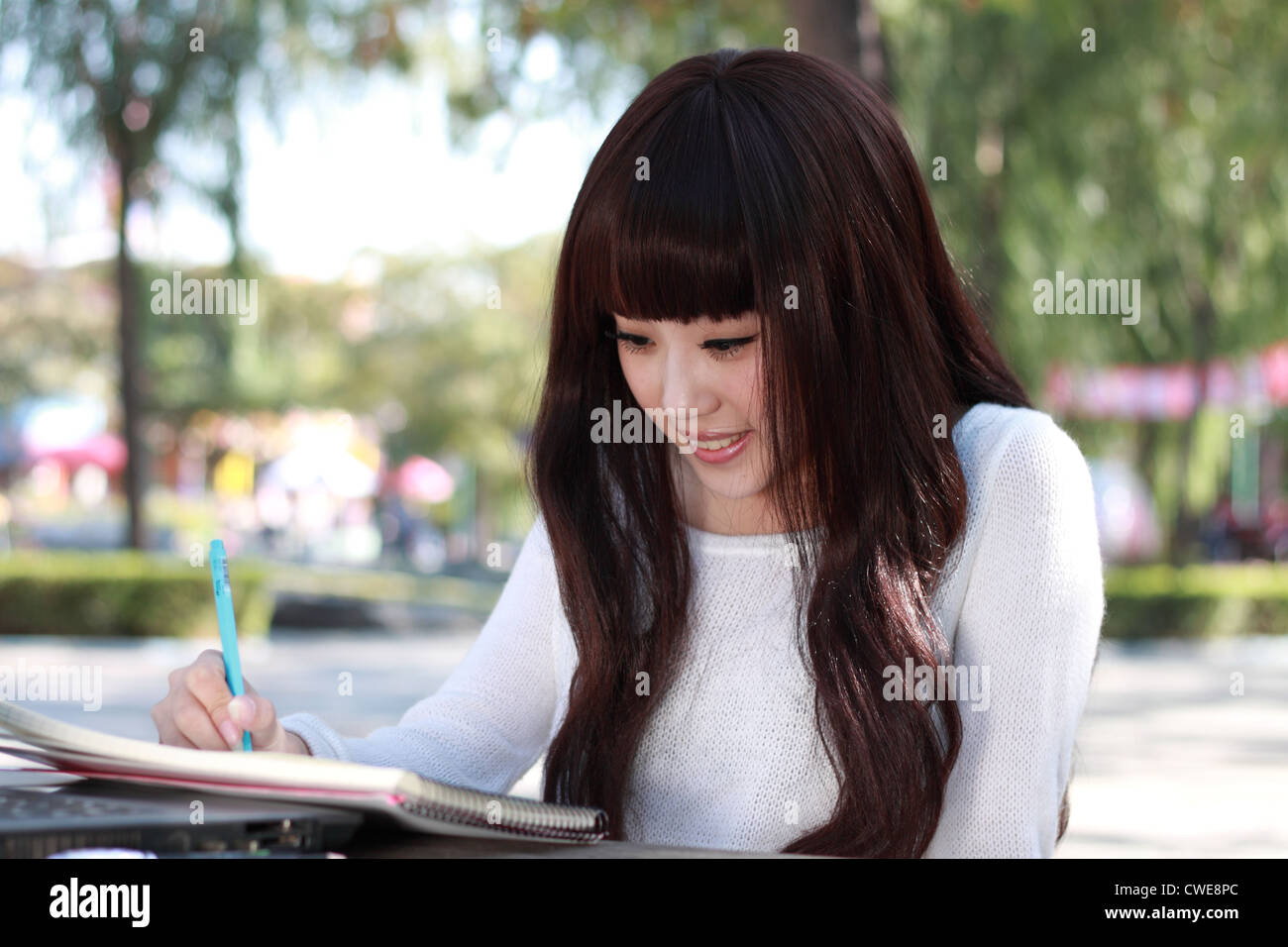 A smiling Asian student is studying Stock Photo - Alamy