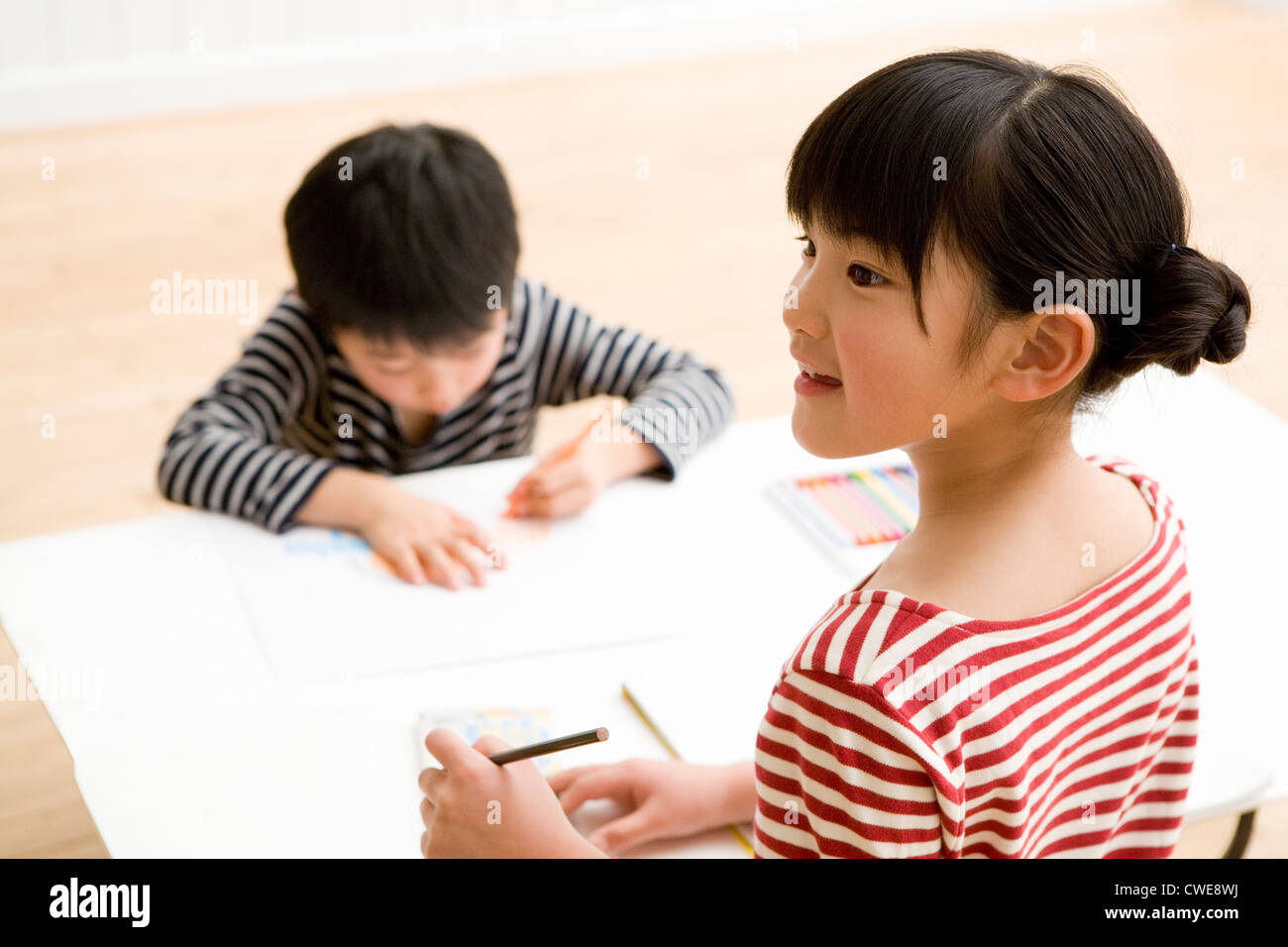 Two kids drawing picture Stock Photo - Alamy