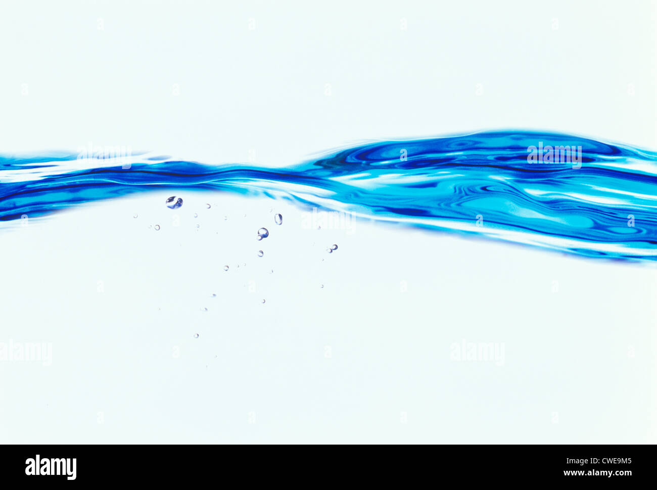 Blue Splashing Water On White, Close-Up Stock Photo - Alamy
