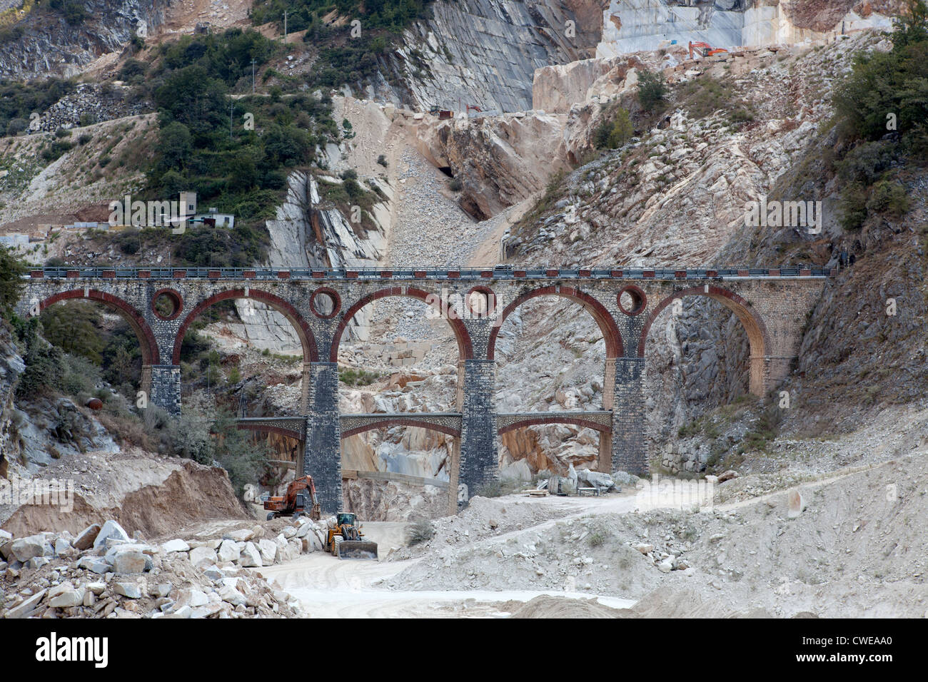 White marble quarry, bridge and excavators. Apuan, Carrara, Tusc Stock ...
