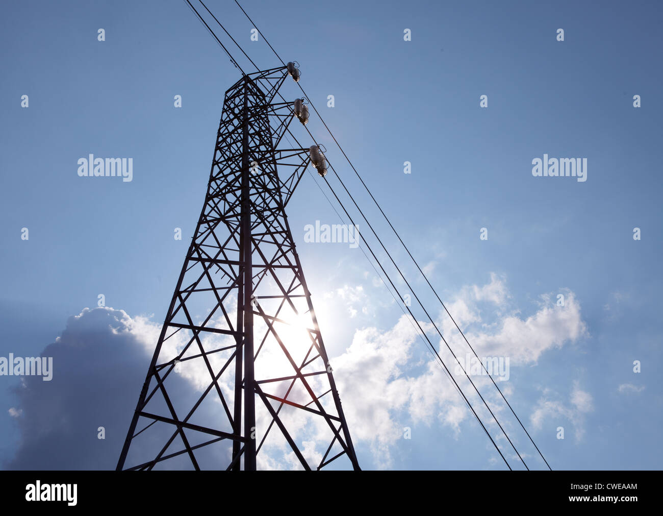 power grid pylon over sunny sky with clouds Stock Photo - Alamy