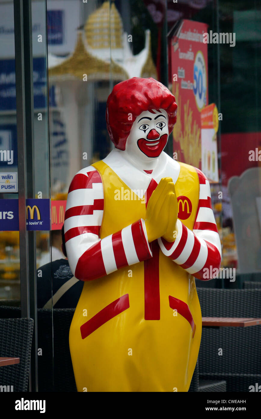 Ronald McDonald Statue doing the traditional Thai welcome Wai at the entrance to a restaurant in ...