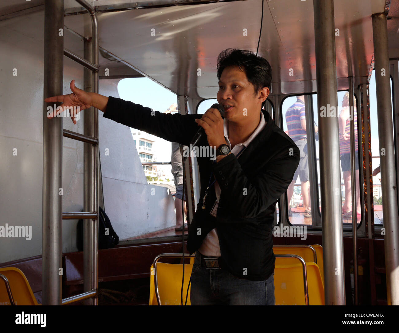 Thai tourist guide on a Leisure boat ride on the Chao Phraya River ...