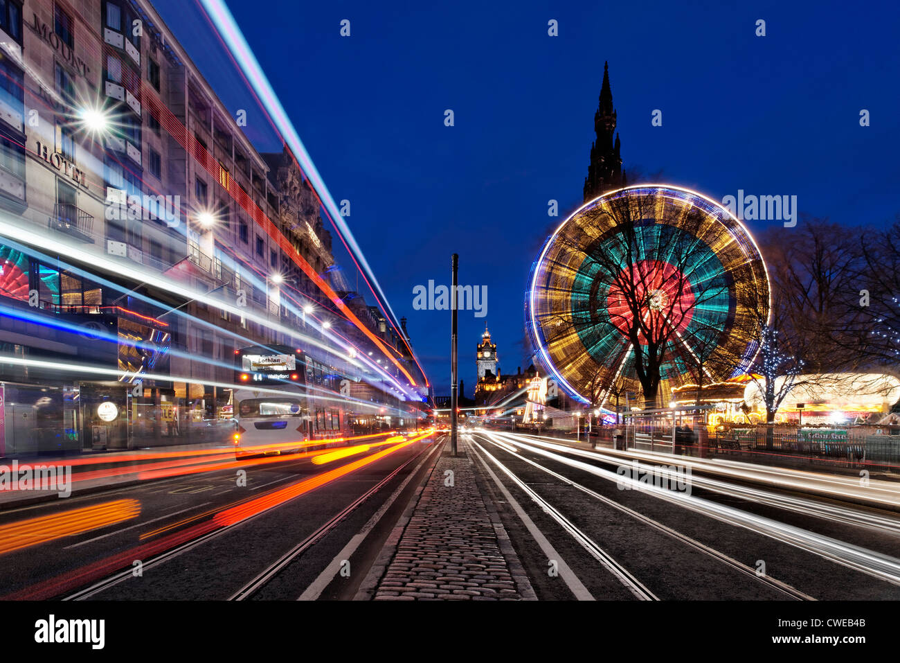The Edinburgh Wheel in front of the Scott Monument with blurred traffic ...