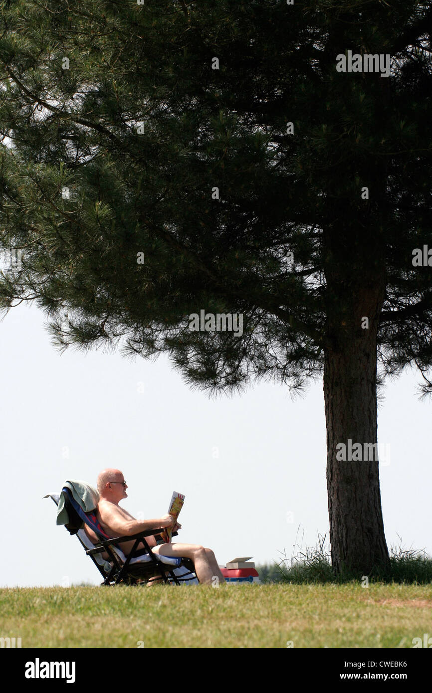 Old man sitting under hi-res stock photography and images - Alamy