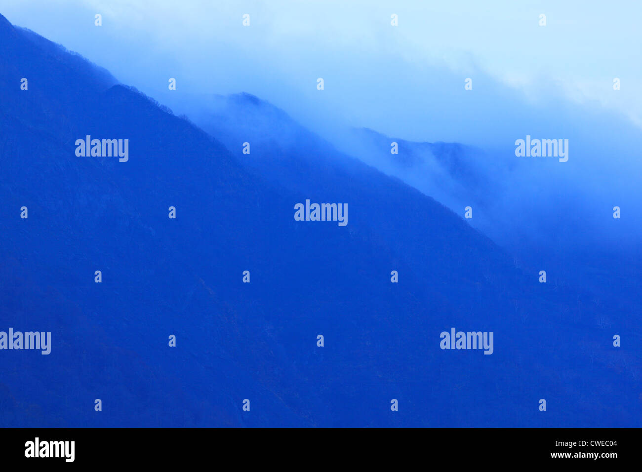 Lush Mountain Ranges Covered By Heavy Fog, Awe Stock Photo - Alamy