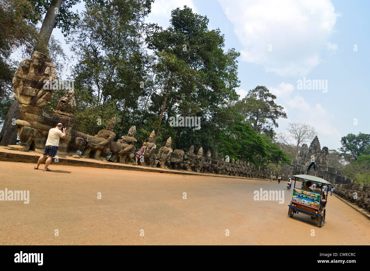 Horizontal view of tourists taking photos of the statues of Gods and ...