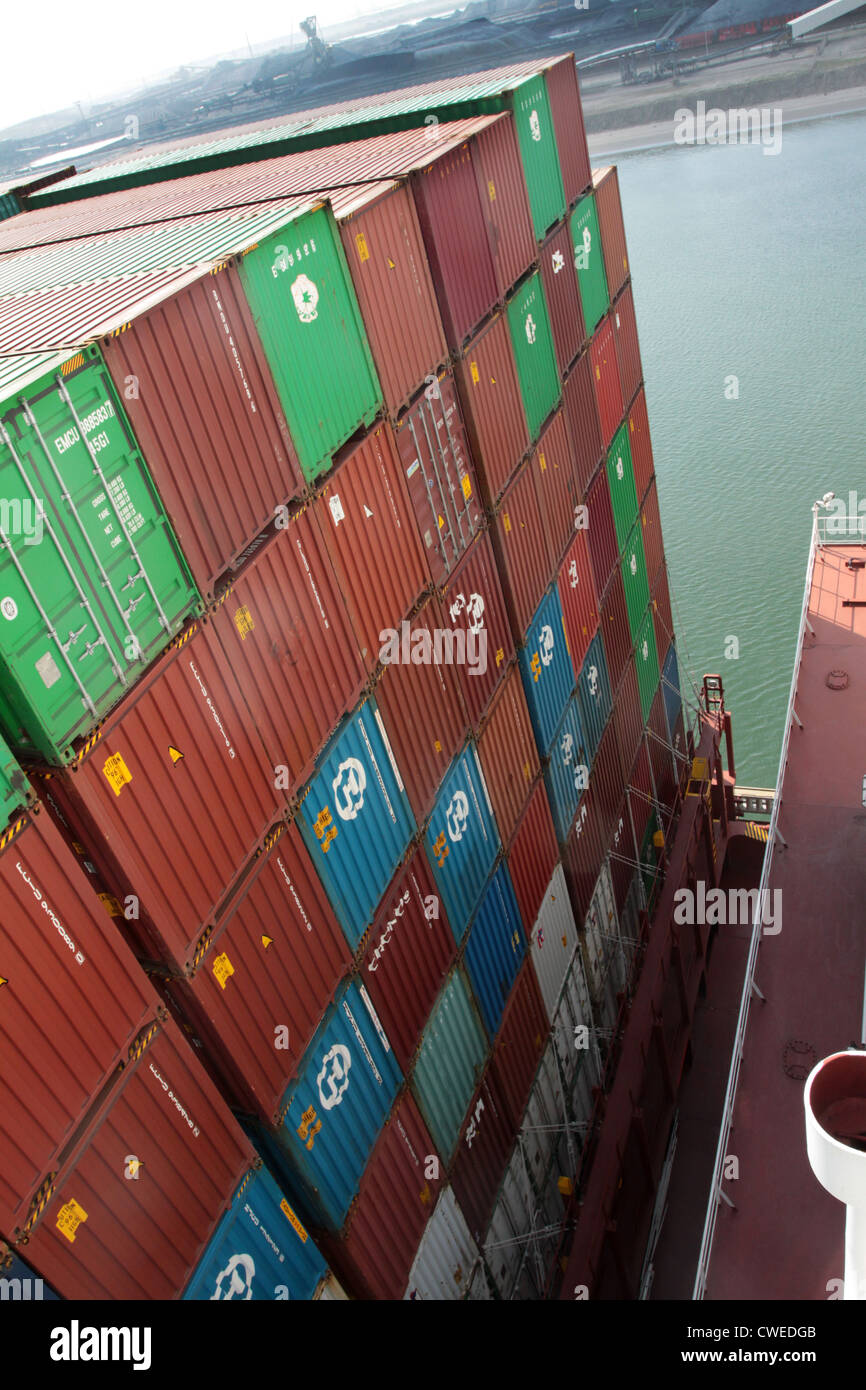 Containers stacked high on deck of a containership, Port of Rotterdam ...