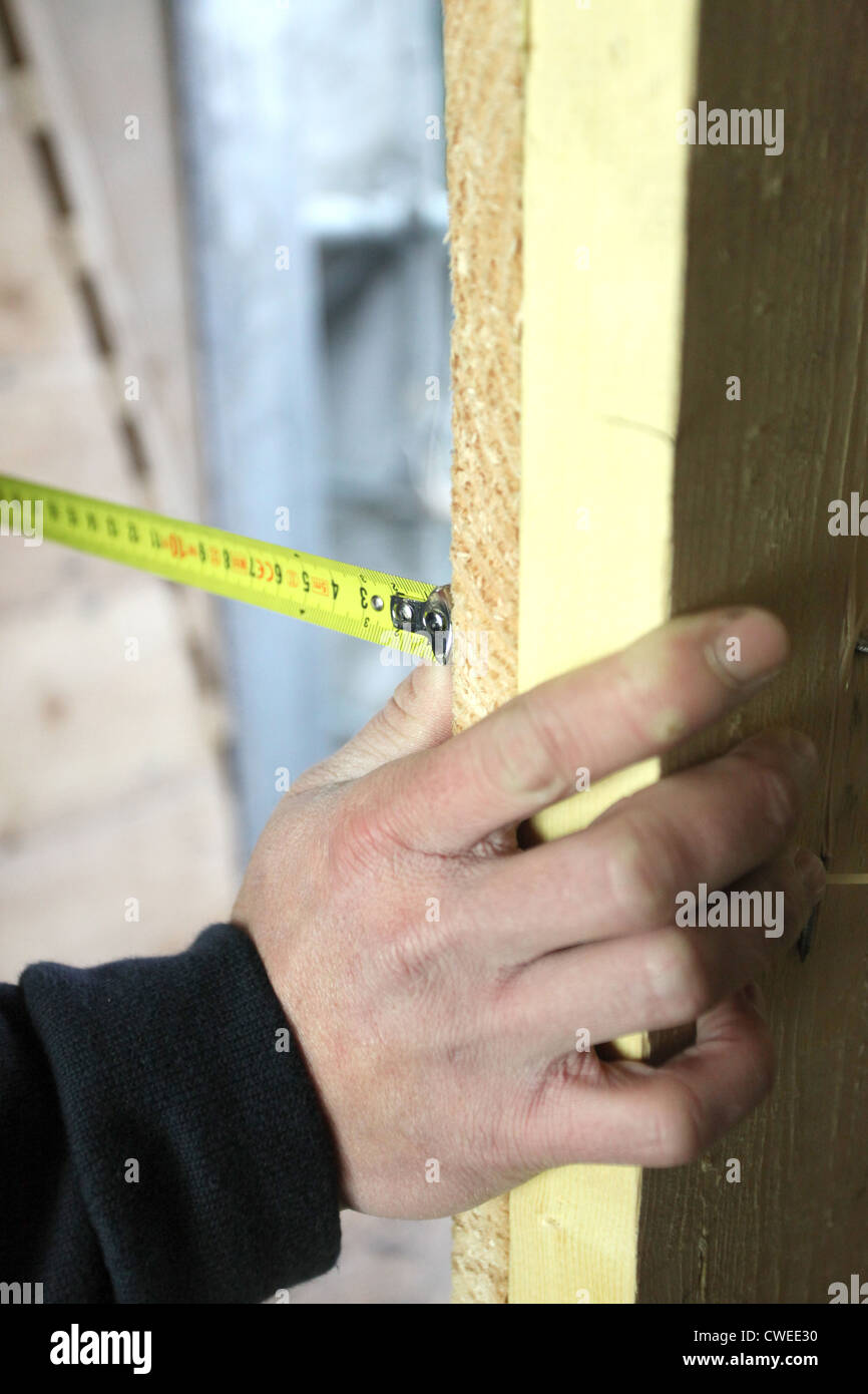 Man measuring wood Stock Photo - Alamy
