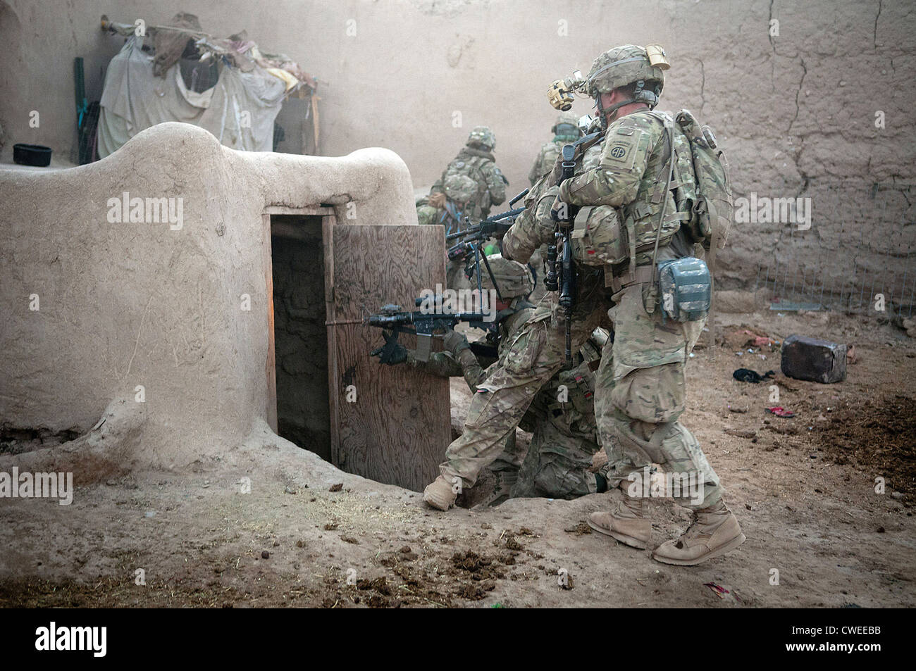 US Paratroopers search a cellar for weapons during a raid on a compound ...