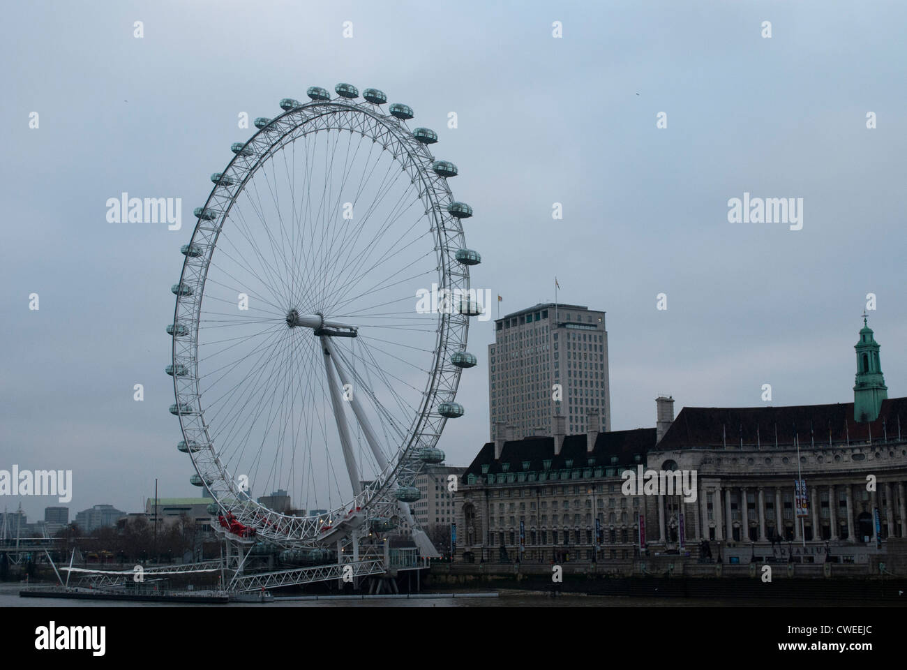 The London Eye silhouetted against a dull cloudy sky Stock Photo - Alamy