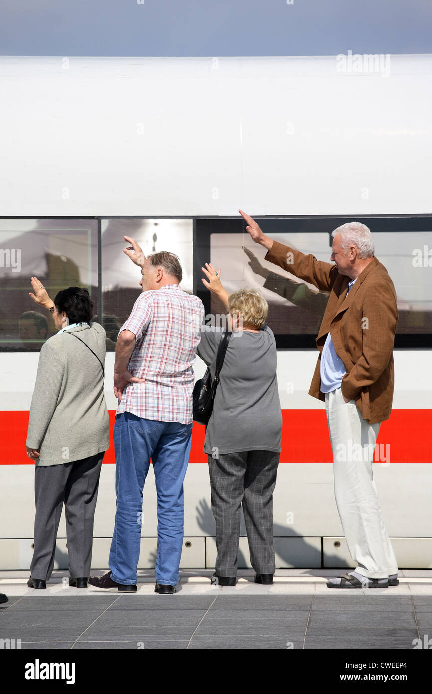 People waving at the window of a train as a farewell Stock Photo - Alamy