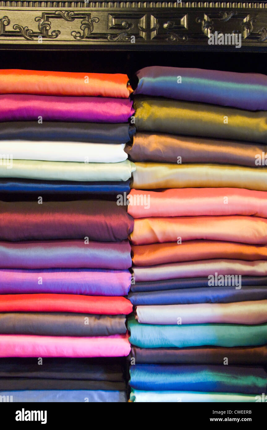 Vertical close up view of lots of different types of colourful silk ...