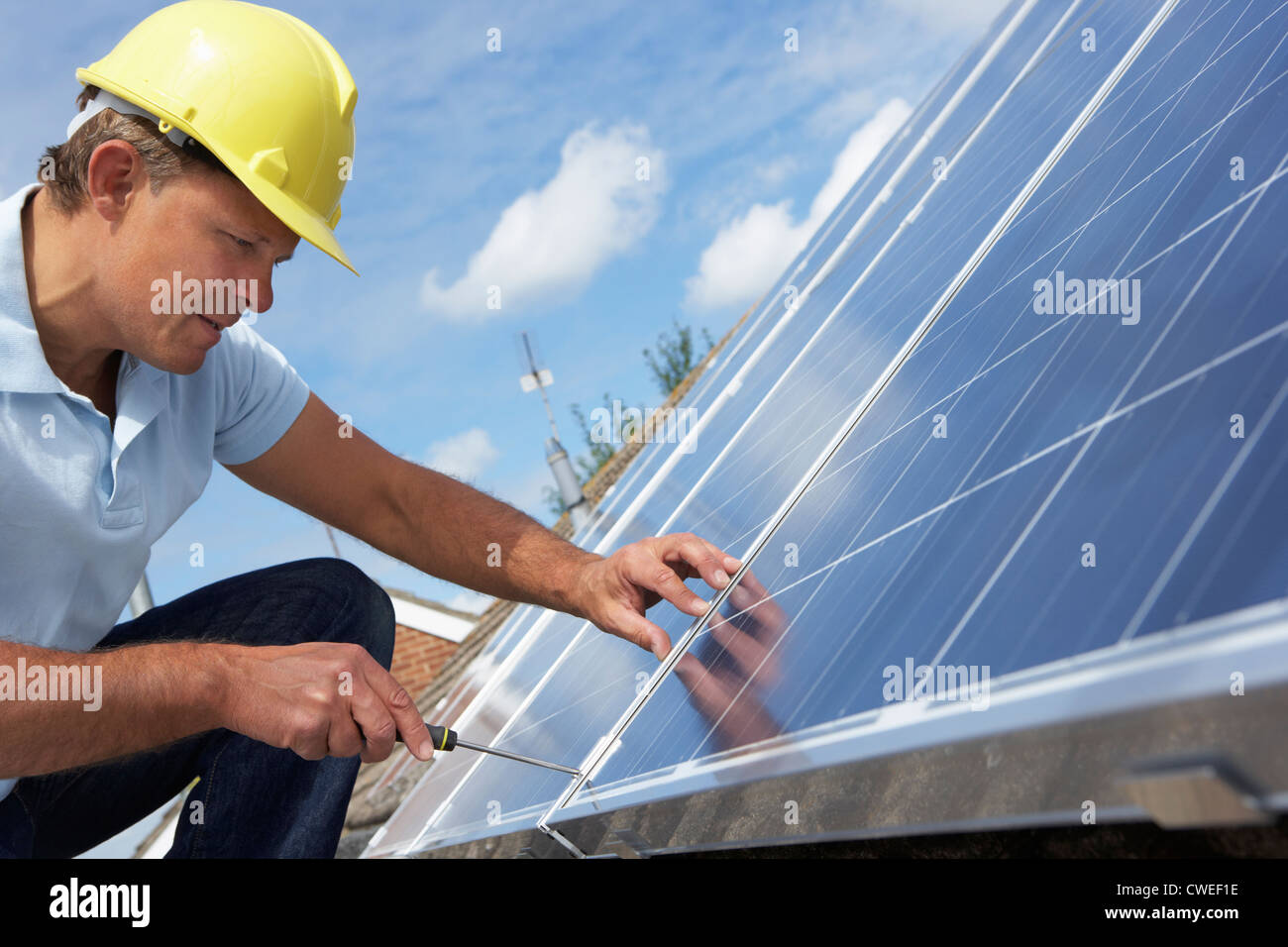 Man installing solar panels Stock Photo - Alamy