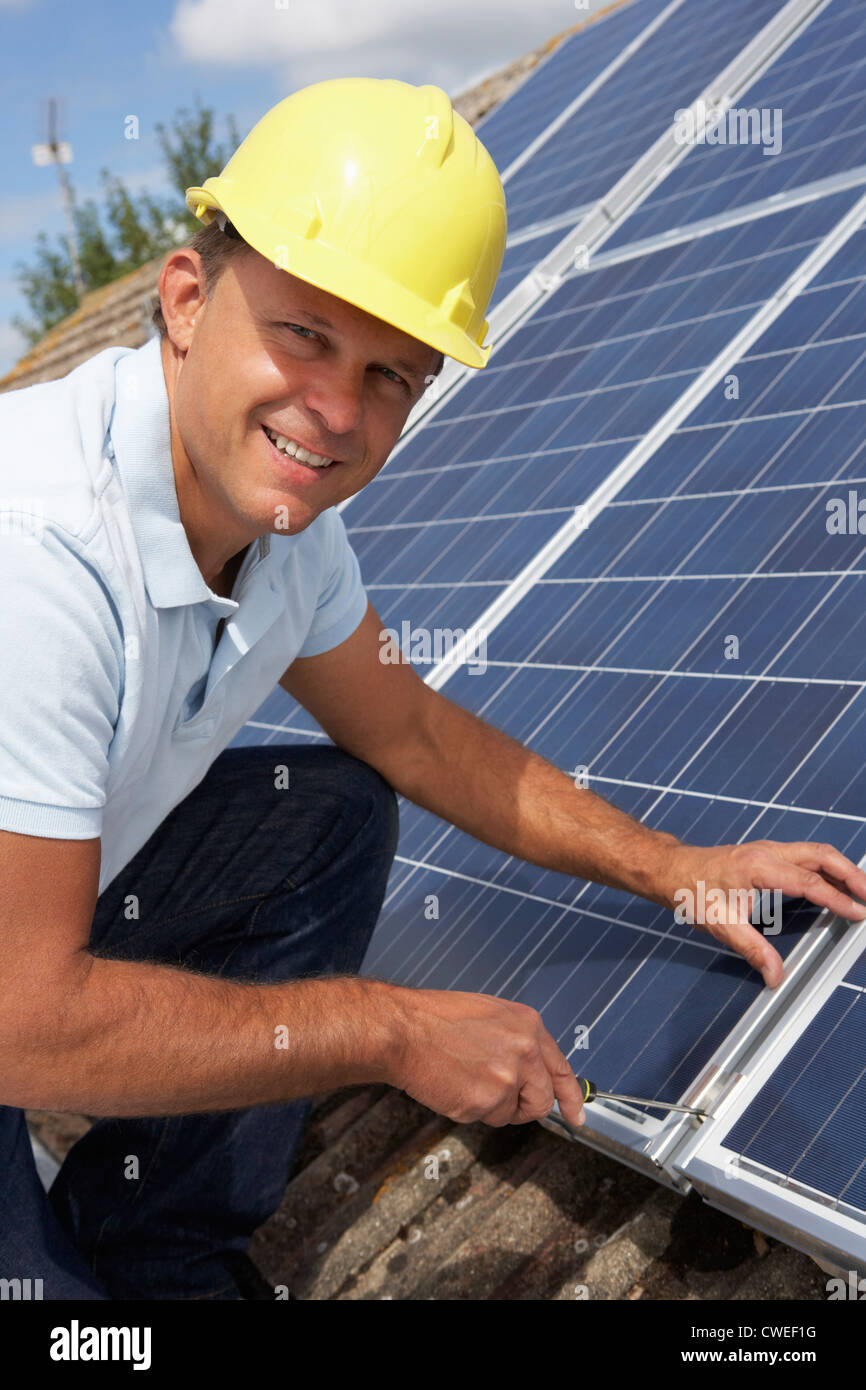 Man installing solar panels Stock Photo - Alamy