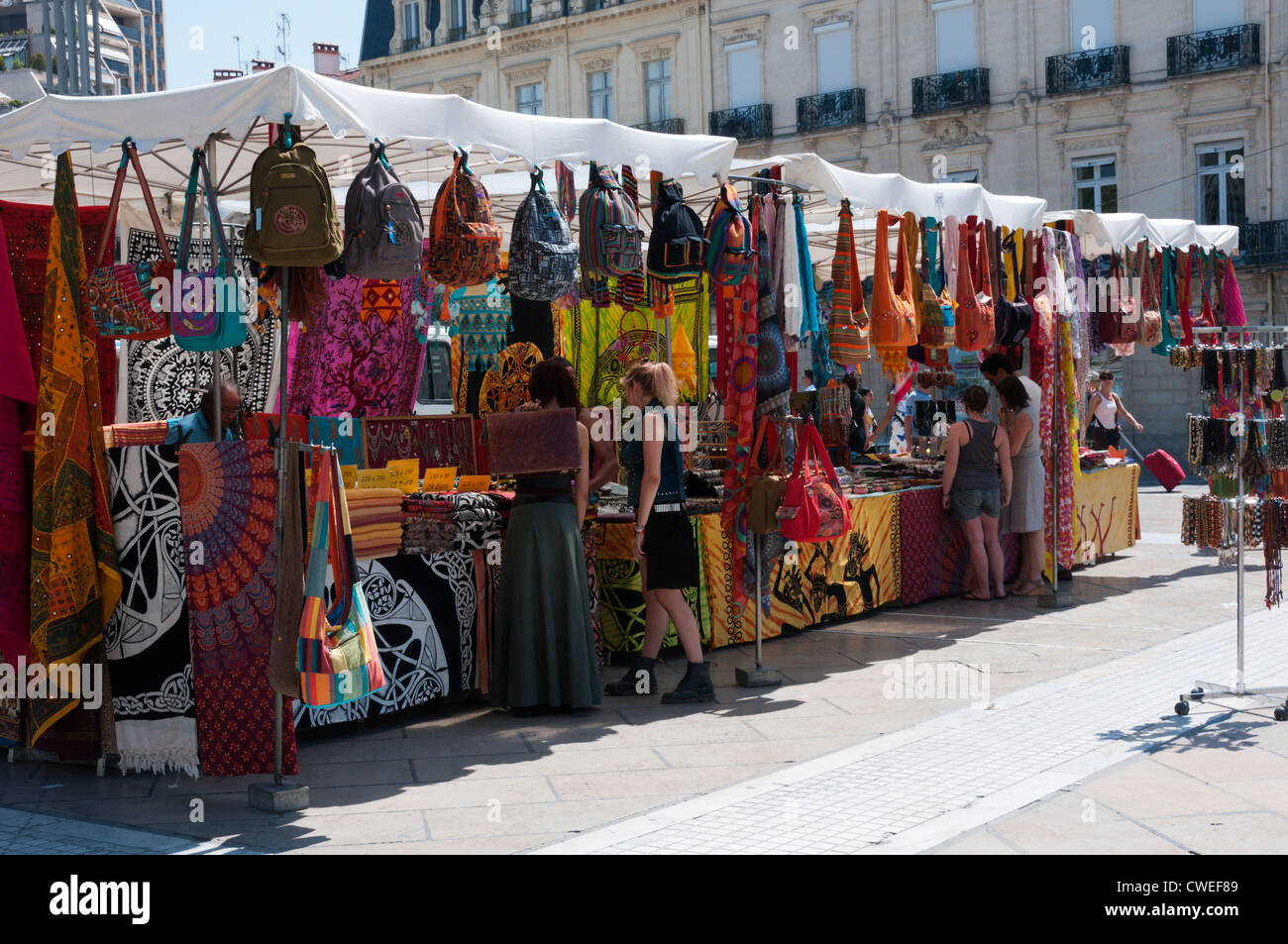 A market stall selling colourful fabrics and bags in the Place de la ...