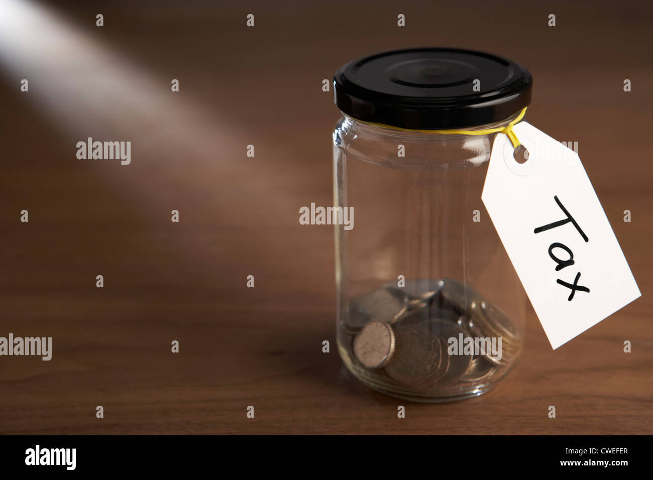 Coins in a jam jar Stock Photo - Alamy