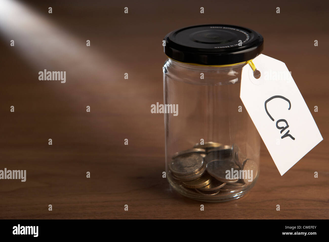Coins in a jam jar Stock Photo - Alamy