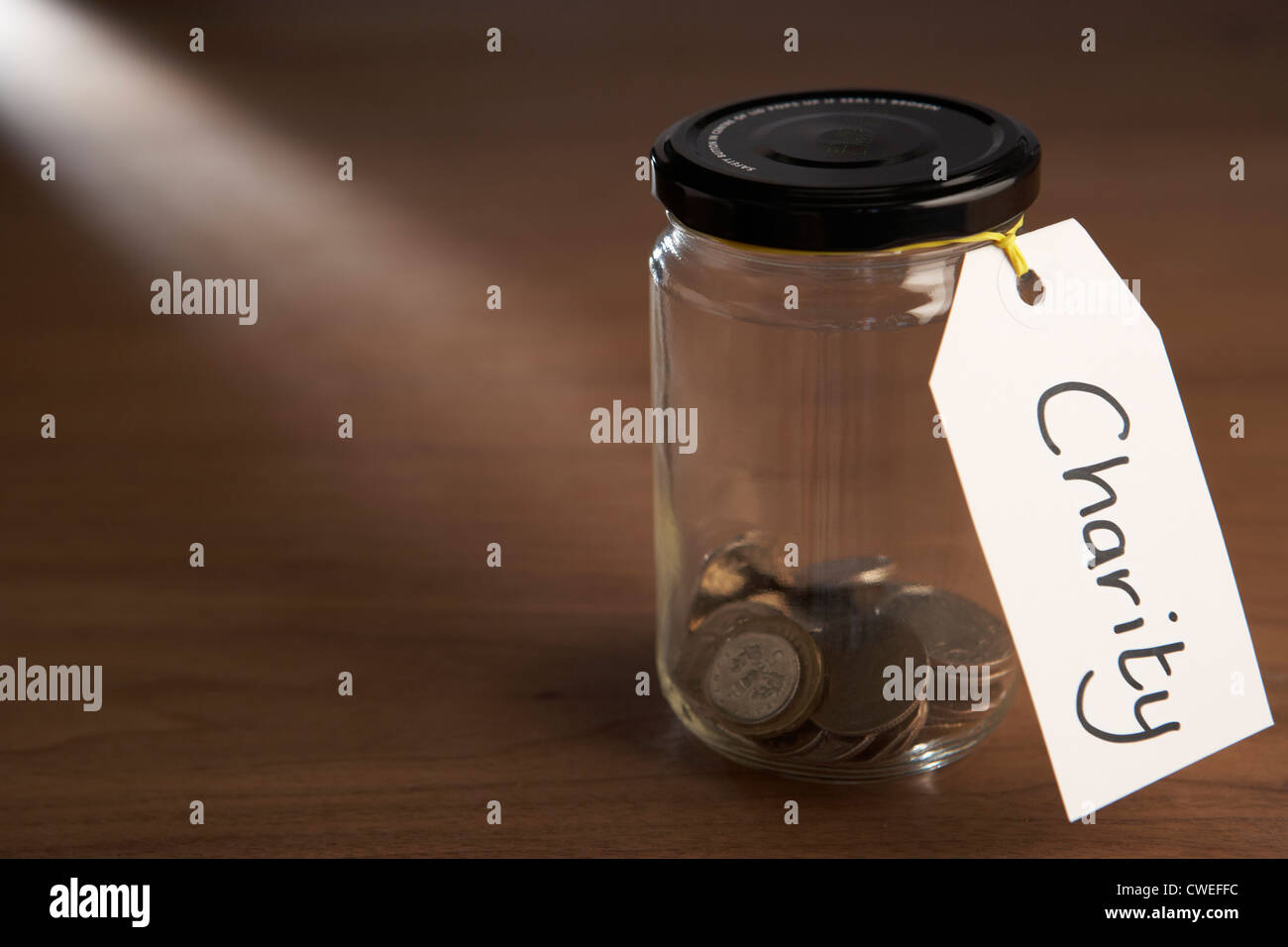Coins in a jam jar Stock Photo - Alamy