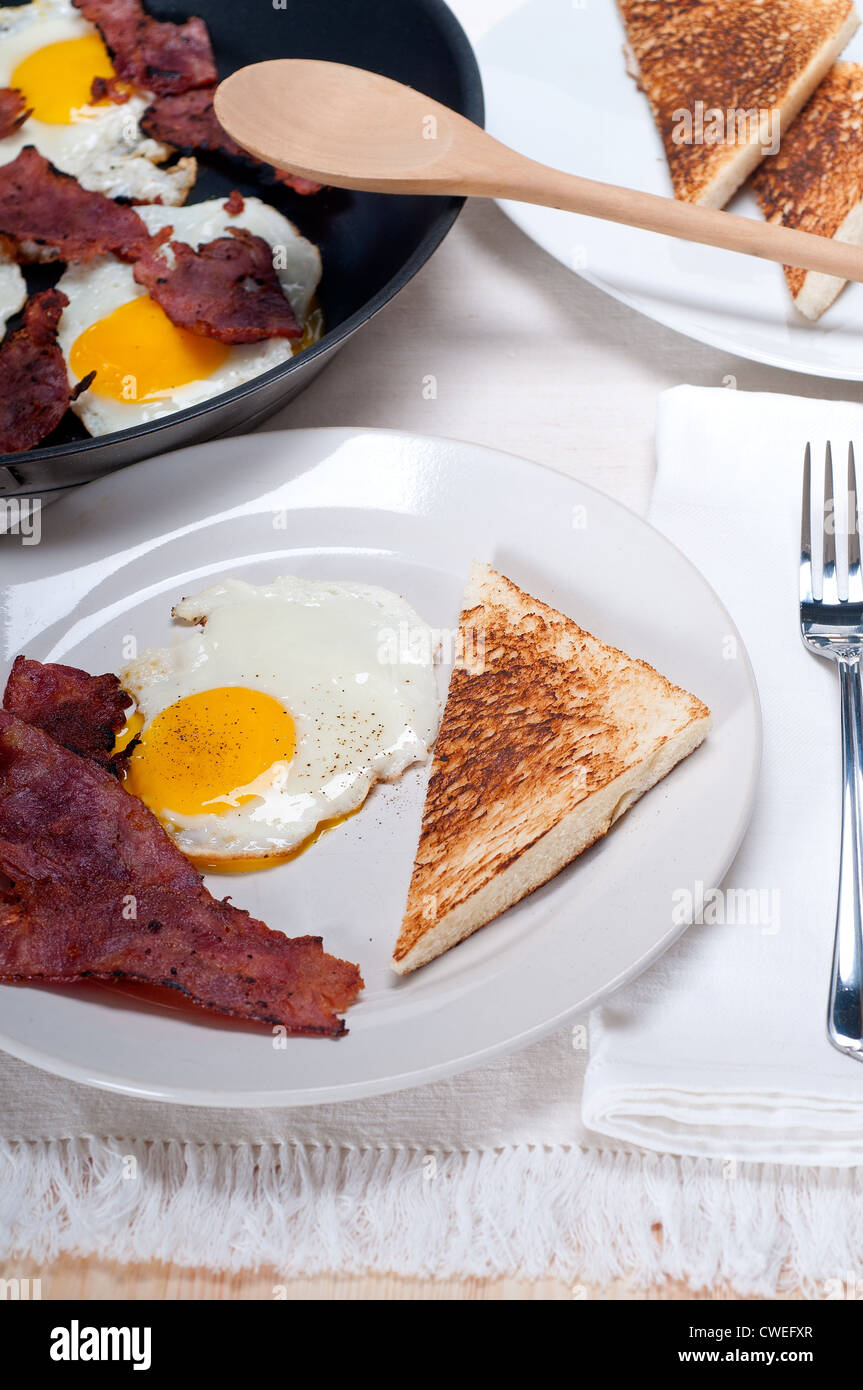 eggs sunny side up with bacon and toast typical english breakfast Stock ...