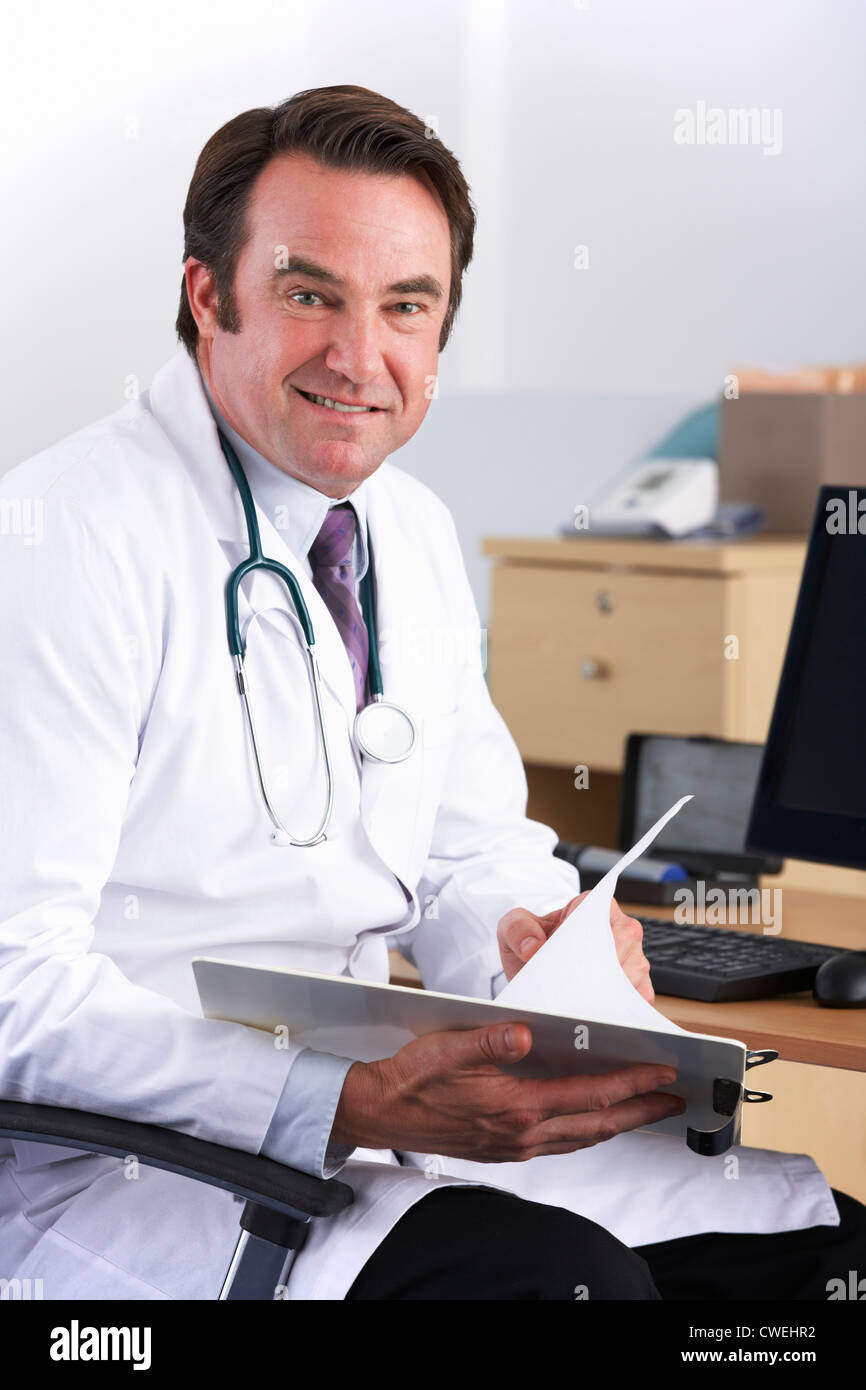 Portrait American doctor sitting at desk Stock Photo - Alamy