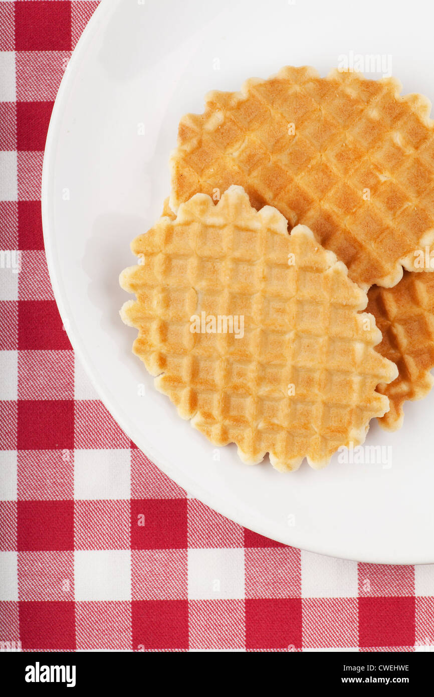 Golden round waffles on a white plate Stock Photo - Alamy