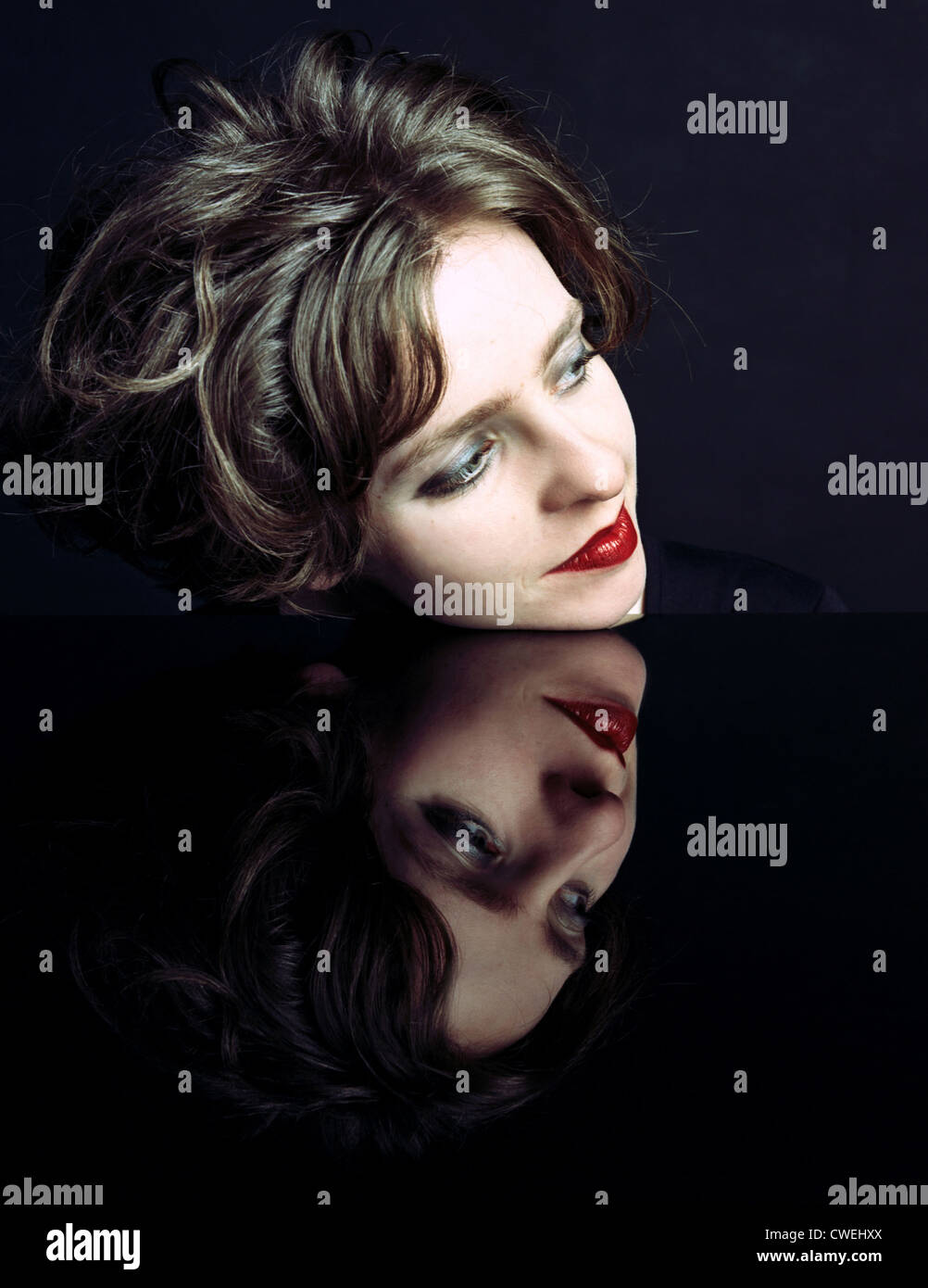 A young woman and her reflection Stock Photo - Alamy
