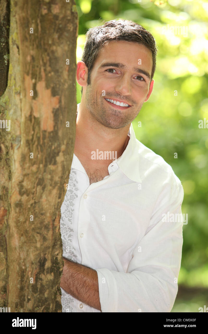 Dark man behind tree hi-res stock photography and images - Alamy