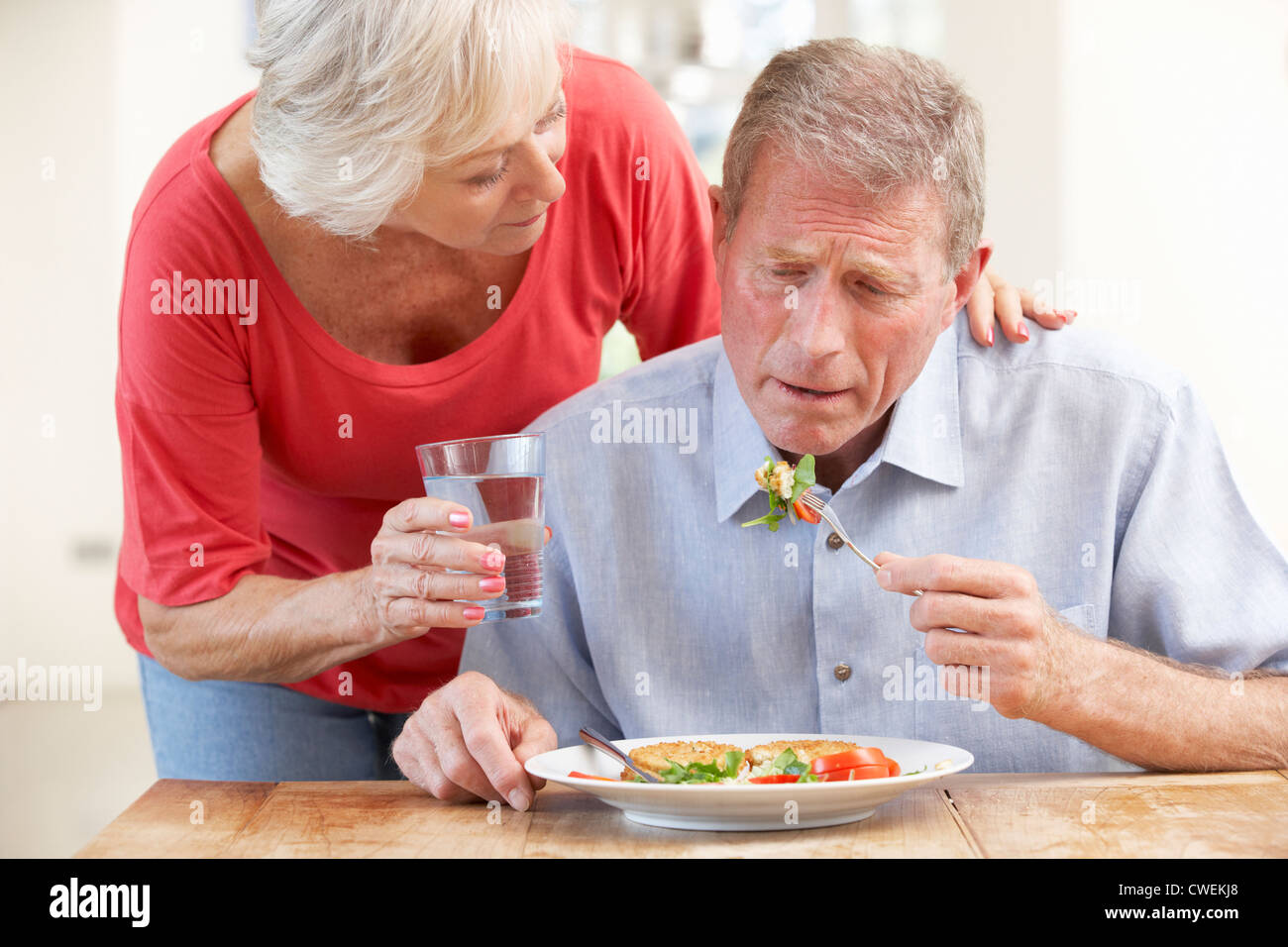 Caring wife feeding sick senior hi-res stock photography and images - Alamy