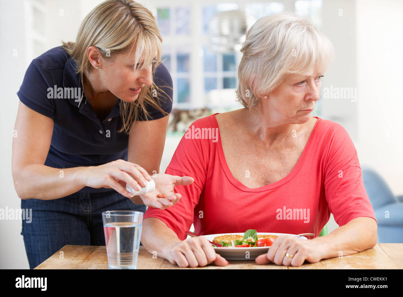 Older woman refusing medication at home Stock Photo - Alamy