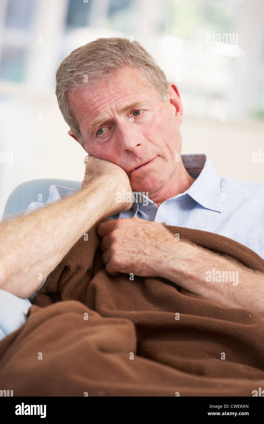 Sick, unhappy older man at home Stock Photo - Alamy