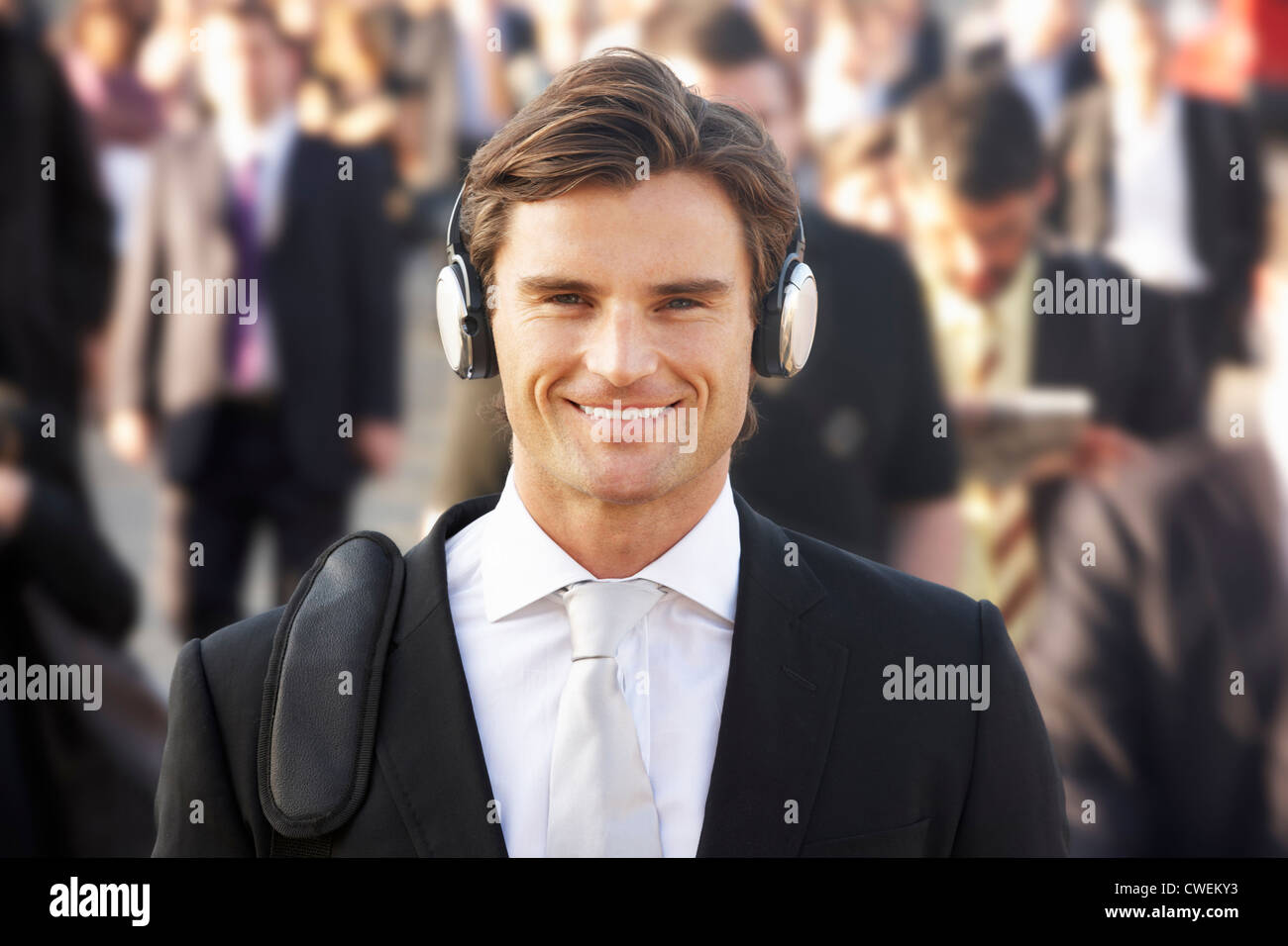 Male commuter in crowd wearing headphones Stock Photo - Alamy