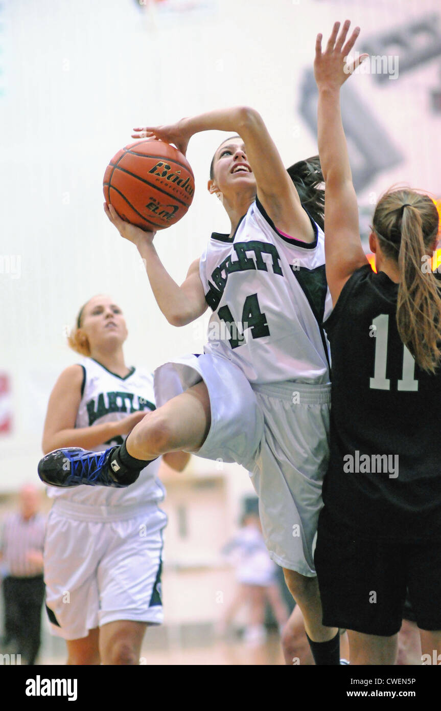 Basketball player completes a drive with a layup attempt during a high ...