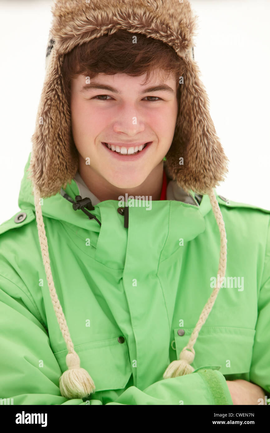 Portrait Of Teenage Boy In Snow Wearing Fur Hat Stock Photo - Alamy