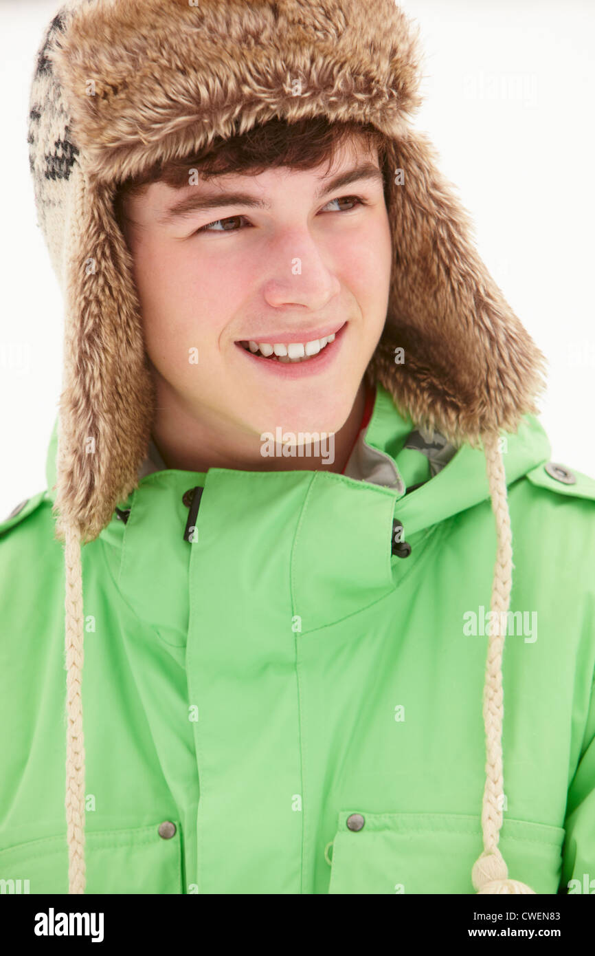 Portrait Of Teenage Boy In Snow Wearing Fur Hat Stock Photo - Alamy