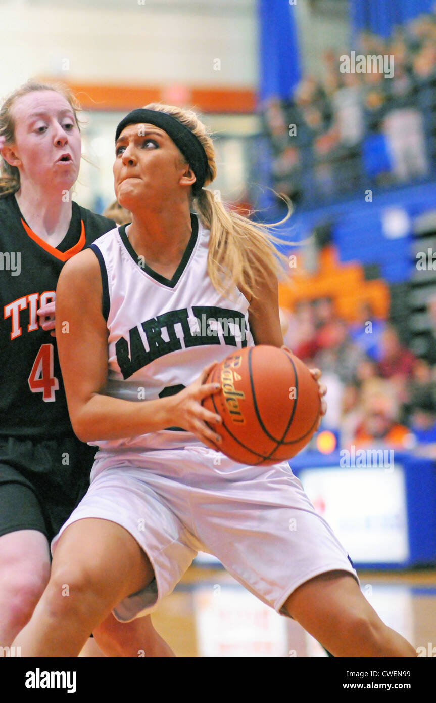 Basketball player posts up to the basket before taking a shot during a ...
