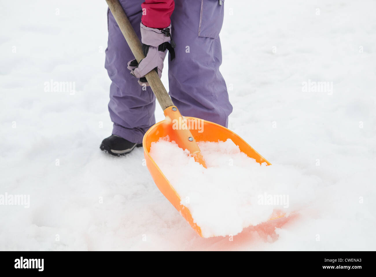 Close Up Of Teenage Girl Shovelling Snow From Path Stock Photo - Alamy