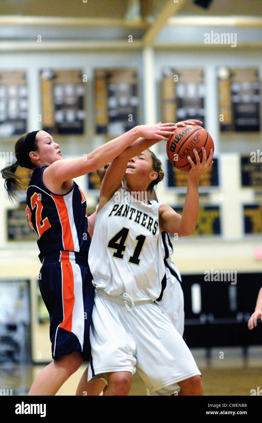 Basketball Player attempts to block ball at Girls High school game. USA ...