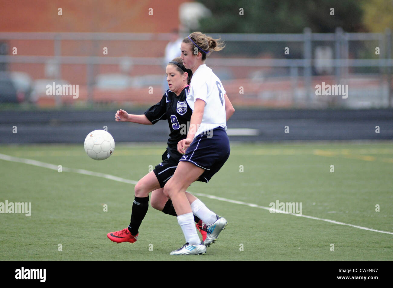 Soccer Players struggle to control the ball just outside the box during ...