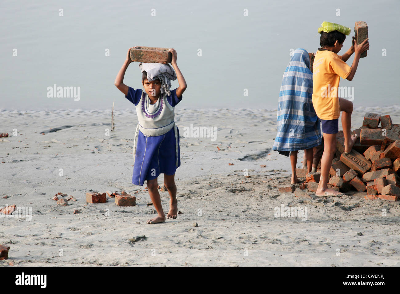 Child workers carry bricks carrying it on his head in Sonakhali, West ...