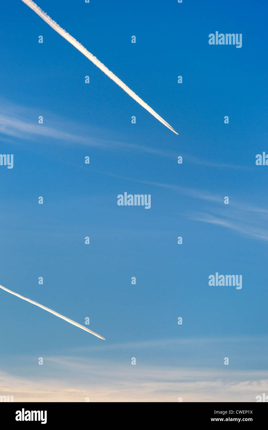 Blue sky with crossing condensation trails hi-res stock photography and ...