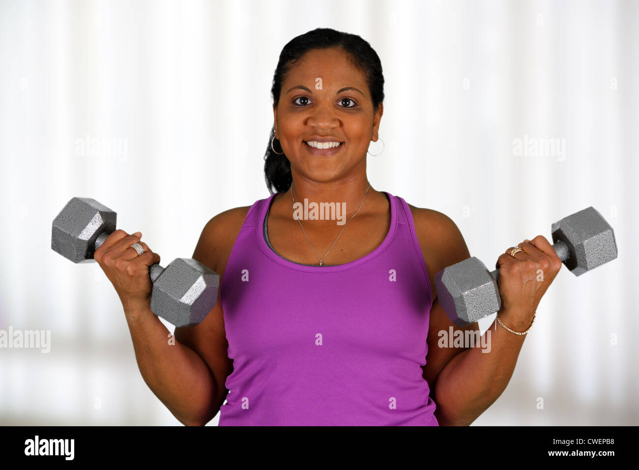 Woman working out while at a gym Stock Photo - Alamy
