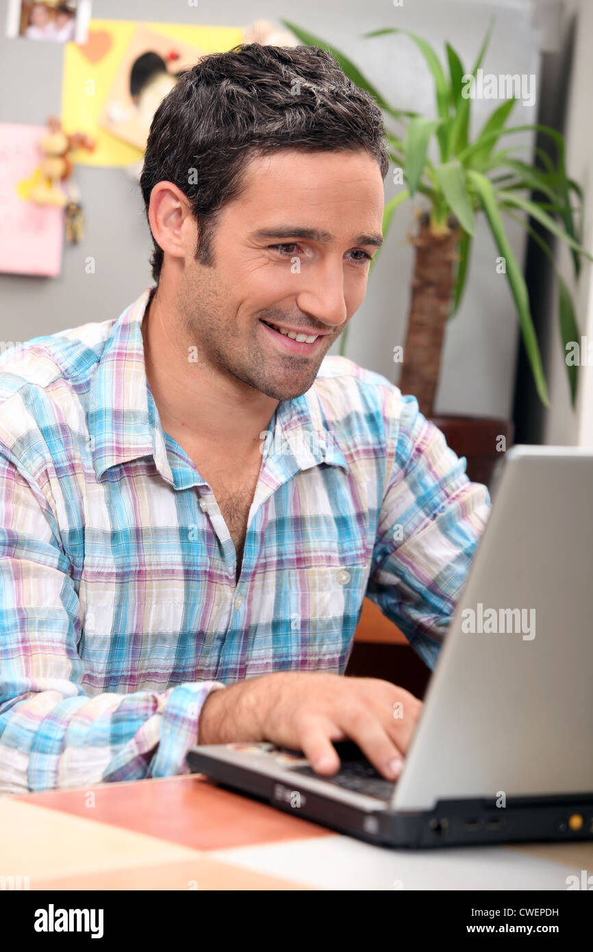 Man laughing in front of computer Stock Photo - Alamy