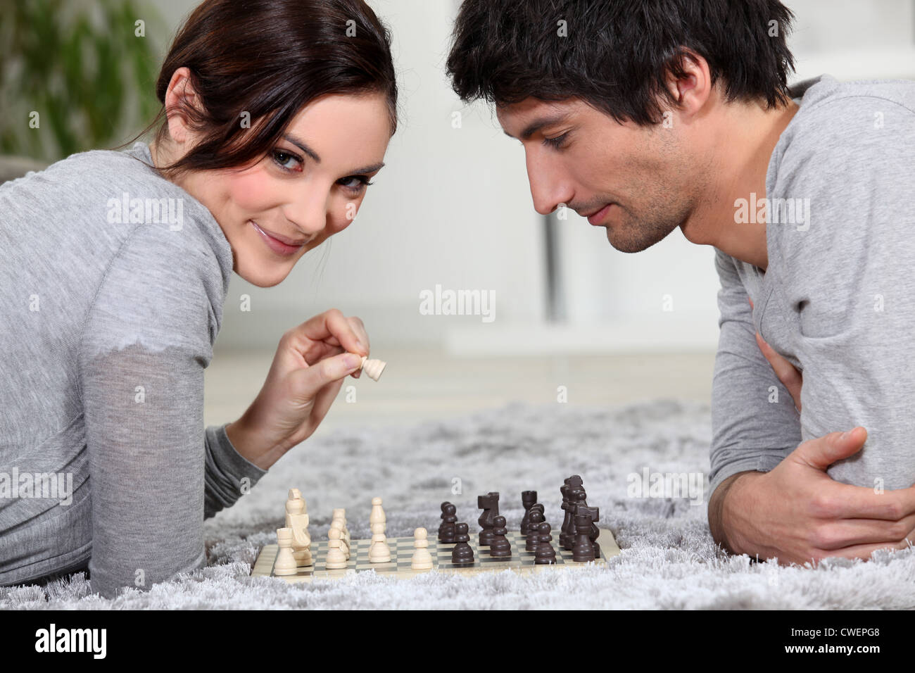 cute young couple playing chess together Stock Photo - Alamy